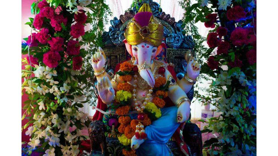 Ganesh Immersion Process and devotee whispers her wish in the ear of ...